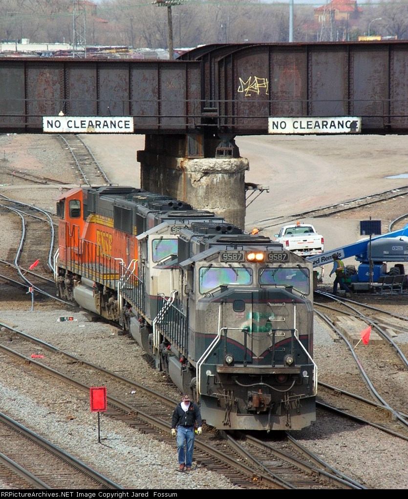 The conductor leads a very dirty, un-patched SD70MAC past work on the Soo Line (Canadian Pacific ...